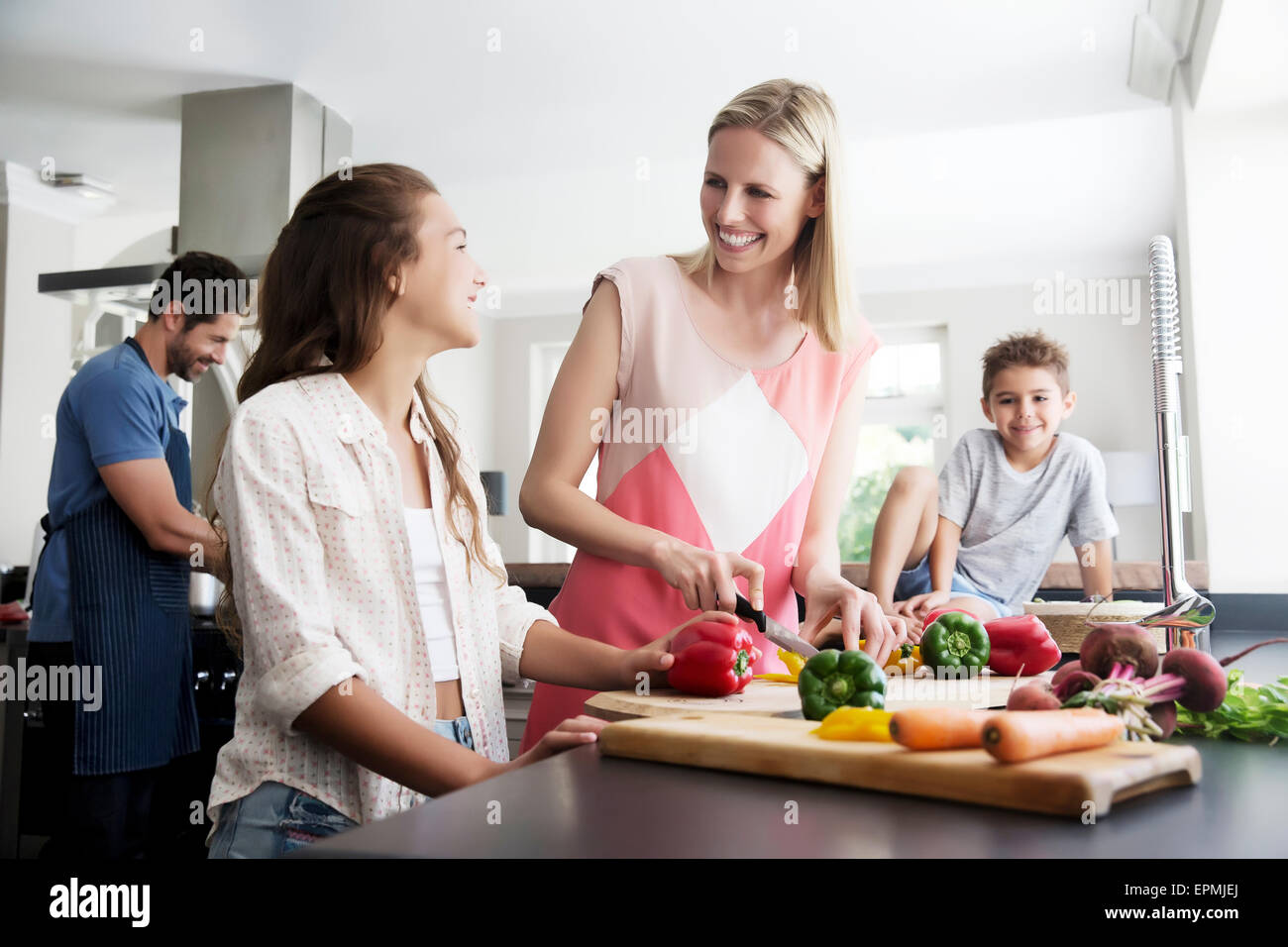 Family preparing food in kitchen Stock Photo - Alamy