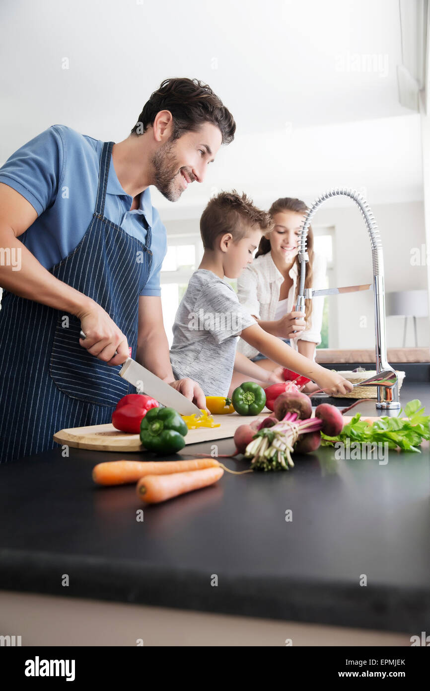 Father and children preparing food in kitchen Stock Photo - Alamy