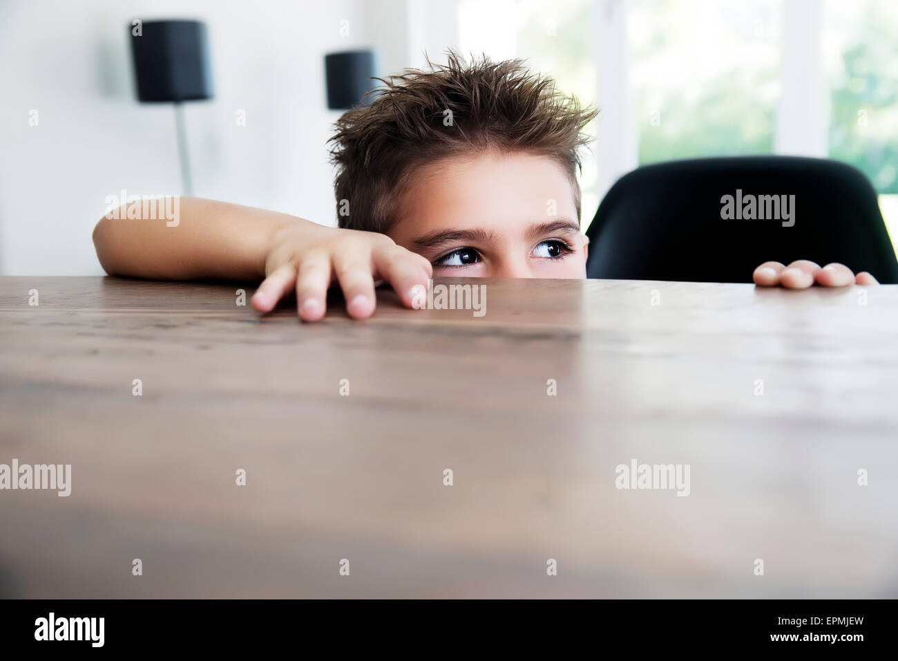 Hiding behind table hi-res stock photography and images - Alamy