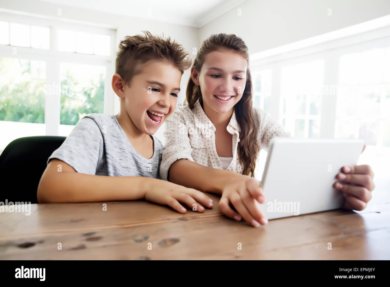 Brother and sister using digital tablet Stock Photo - Alamy