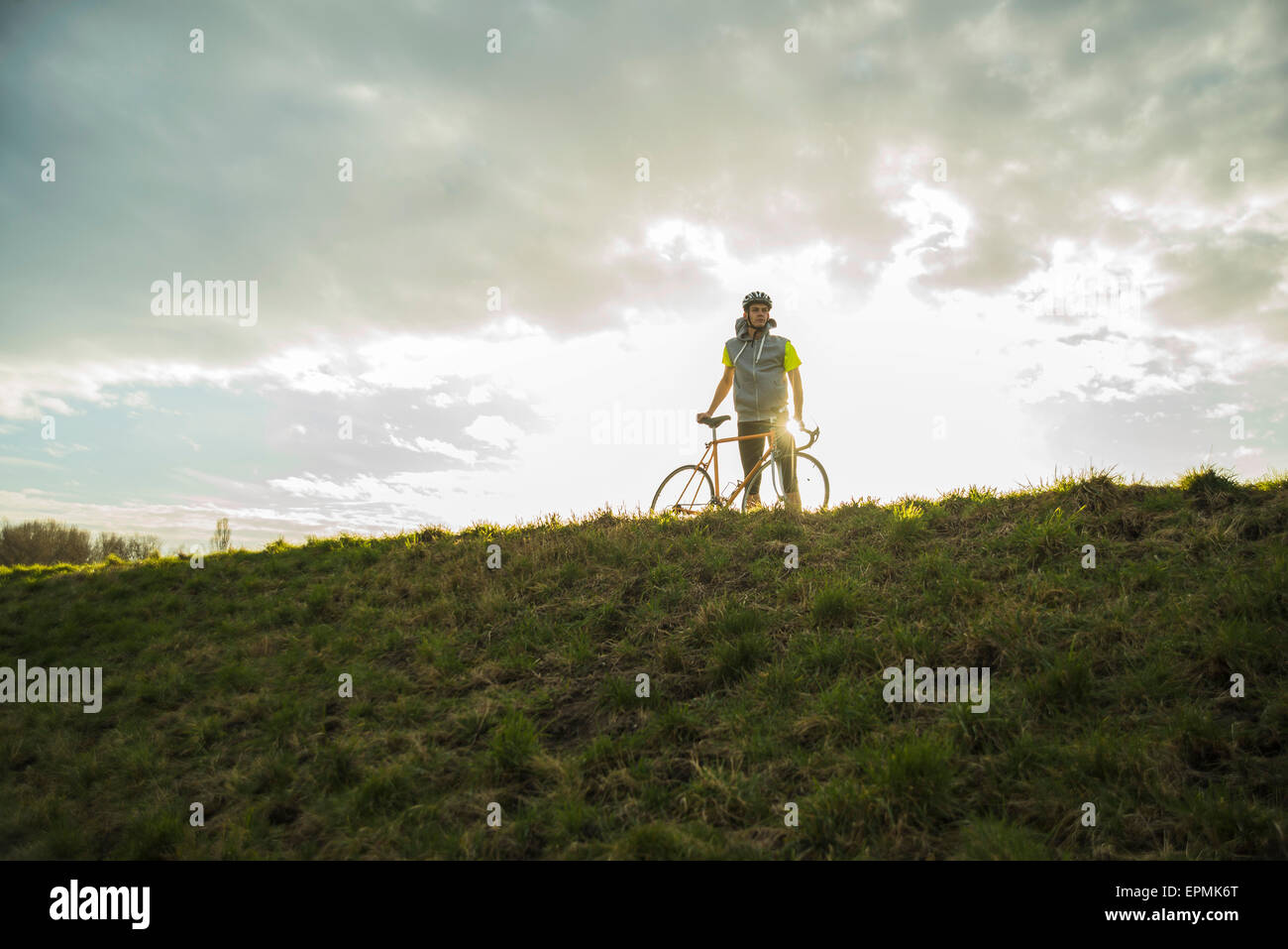 Germany, Mannheim, young man standing with bicycle Stock Photo - Alamy