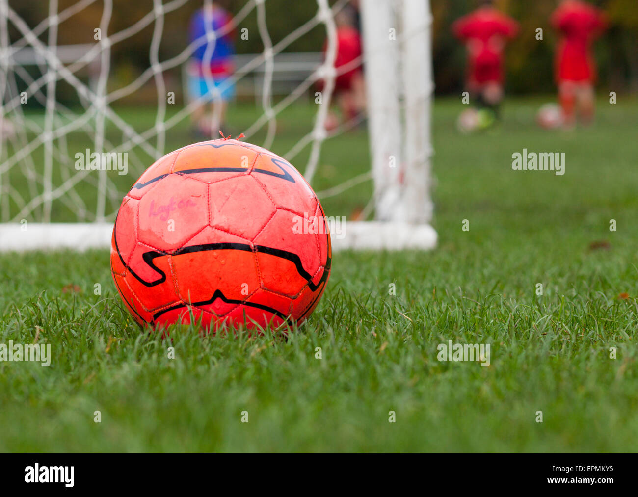 An orange football on a playing field Stock Photo - Alamy