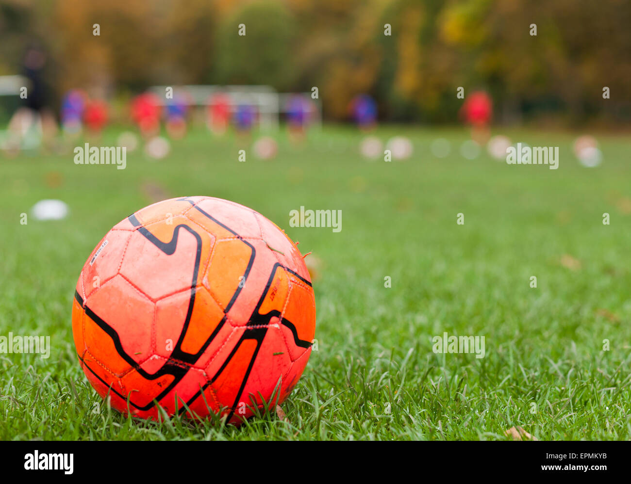 An orange football on a playing field Stock Photo - Alamy