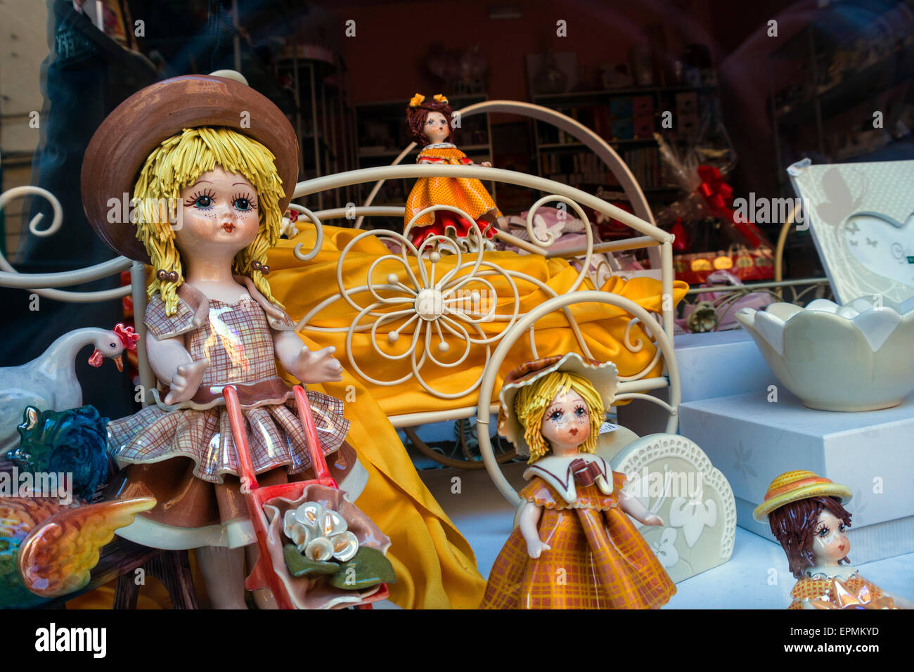 Four colourful dolls in a window display of a shop in Verona, Northern ...