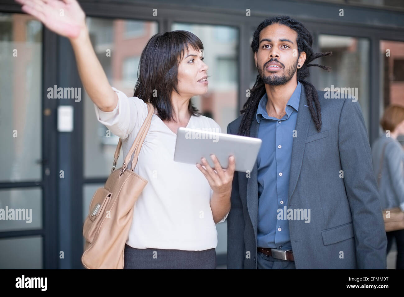 Travelling businessman asking woman for directions Stock Photo - Alamy