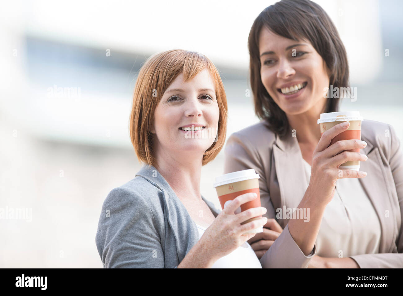 Businesswomen taking a break, drinking coffee Stock Photo - Alamy