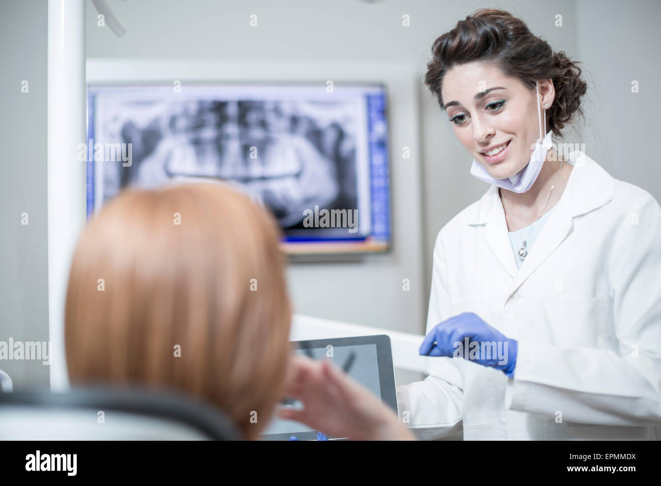 Dentist explaining a procedure and results with a patient Stock Photo ...