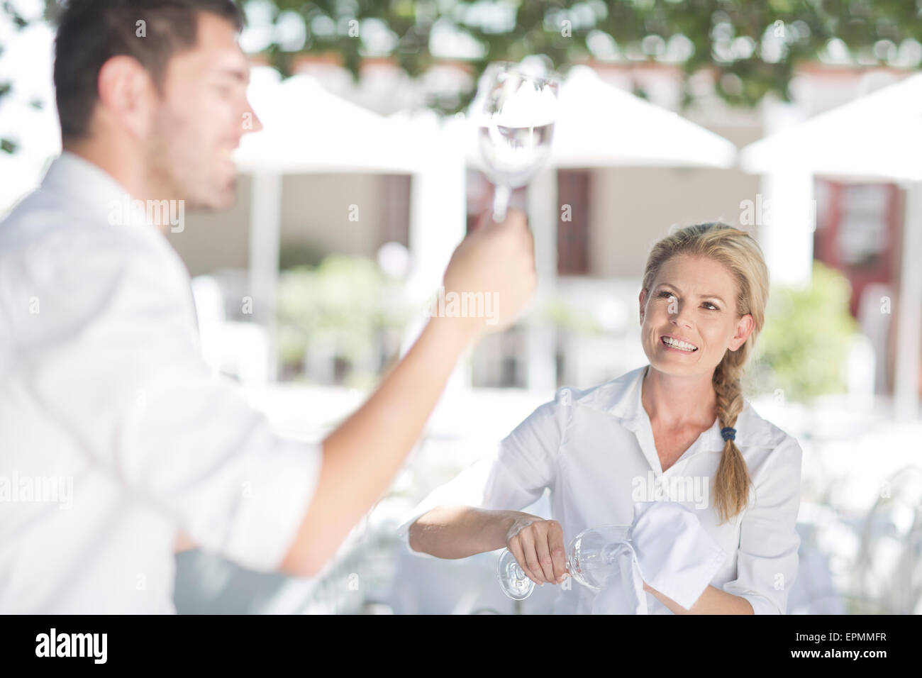 Waiters setting up an outdoor restaurant table Stock Photo - Alamy
