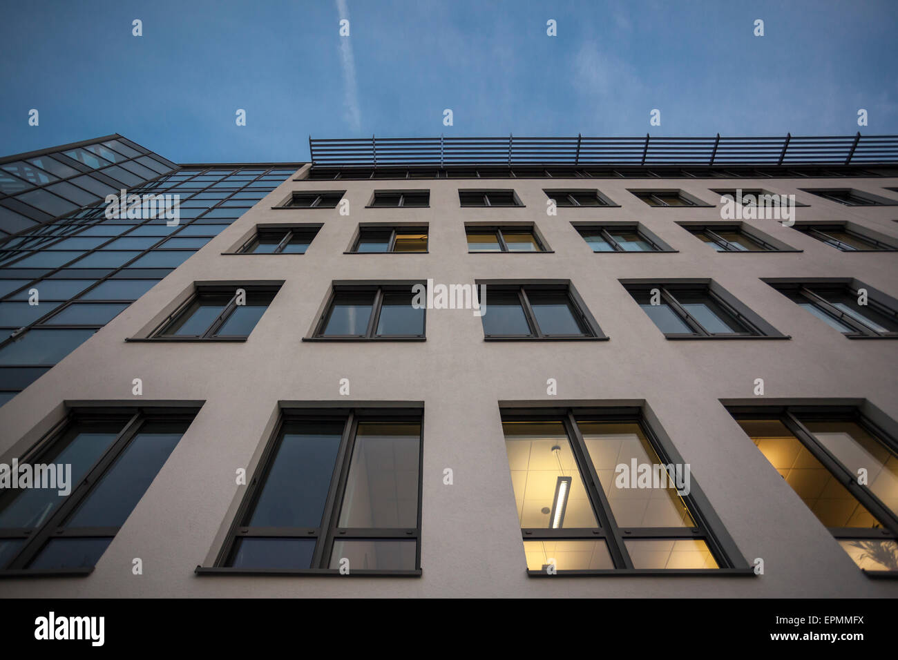 Germany, Munich, facade of office building at evening twilight Stock ...