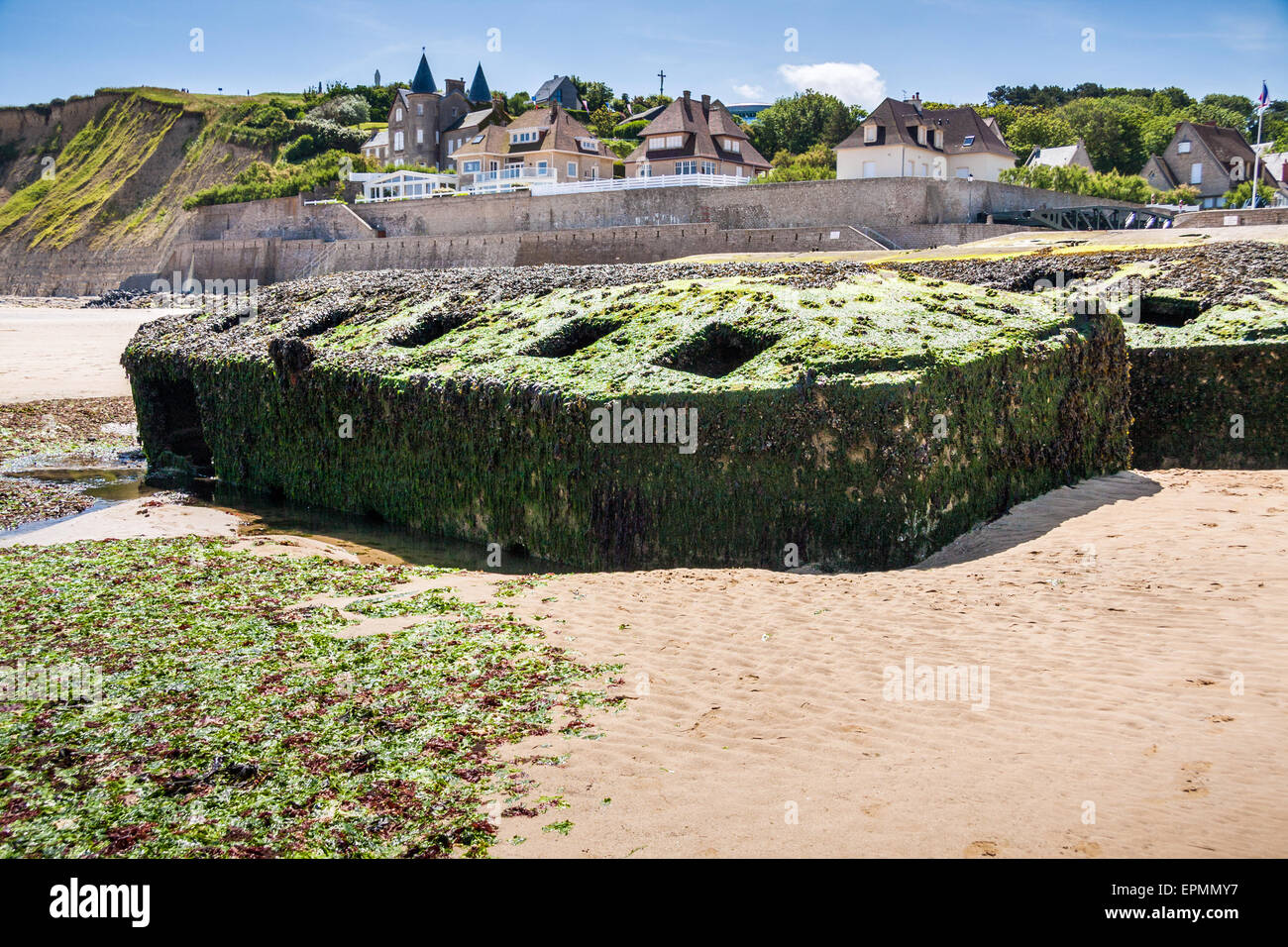 Arromanches les Bains beach with the remains of the Mulberry harbour in ...