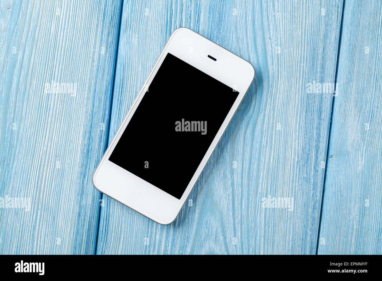 White smartphone on blue wooden table. Top view Stock Photo - Alamy