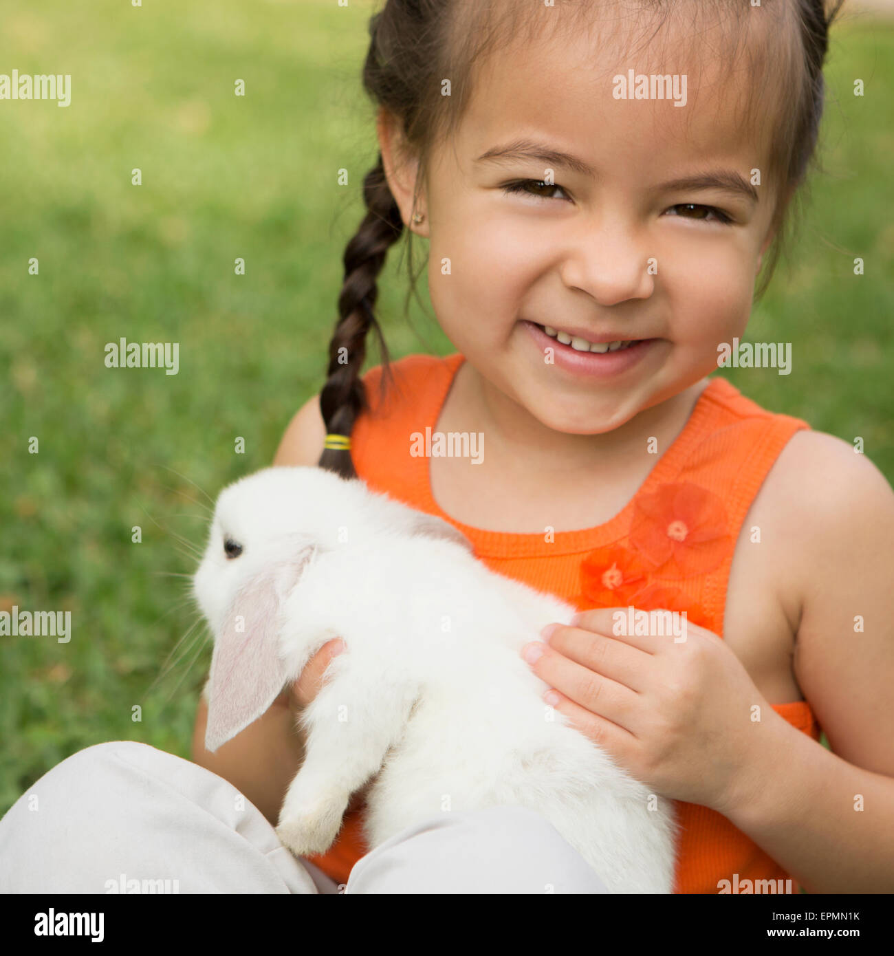 Child stroking rabbit hi-res stock photography and images - Alamy