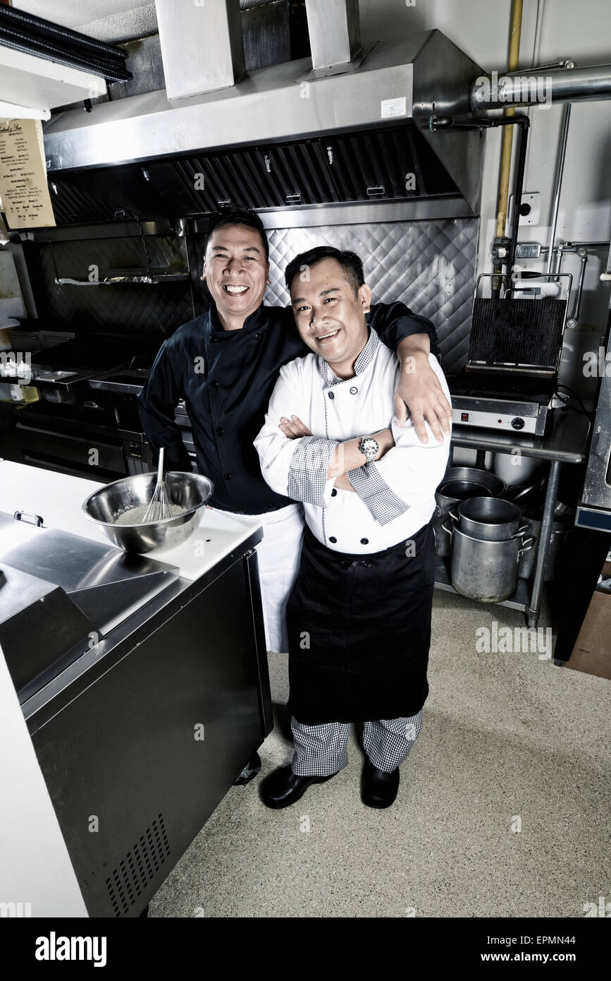 Two cooks in a commercial restaurant kitchen Stock Photo - Alamy