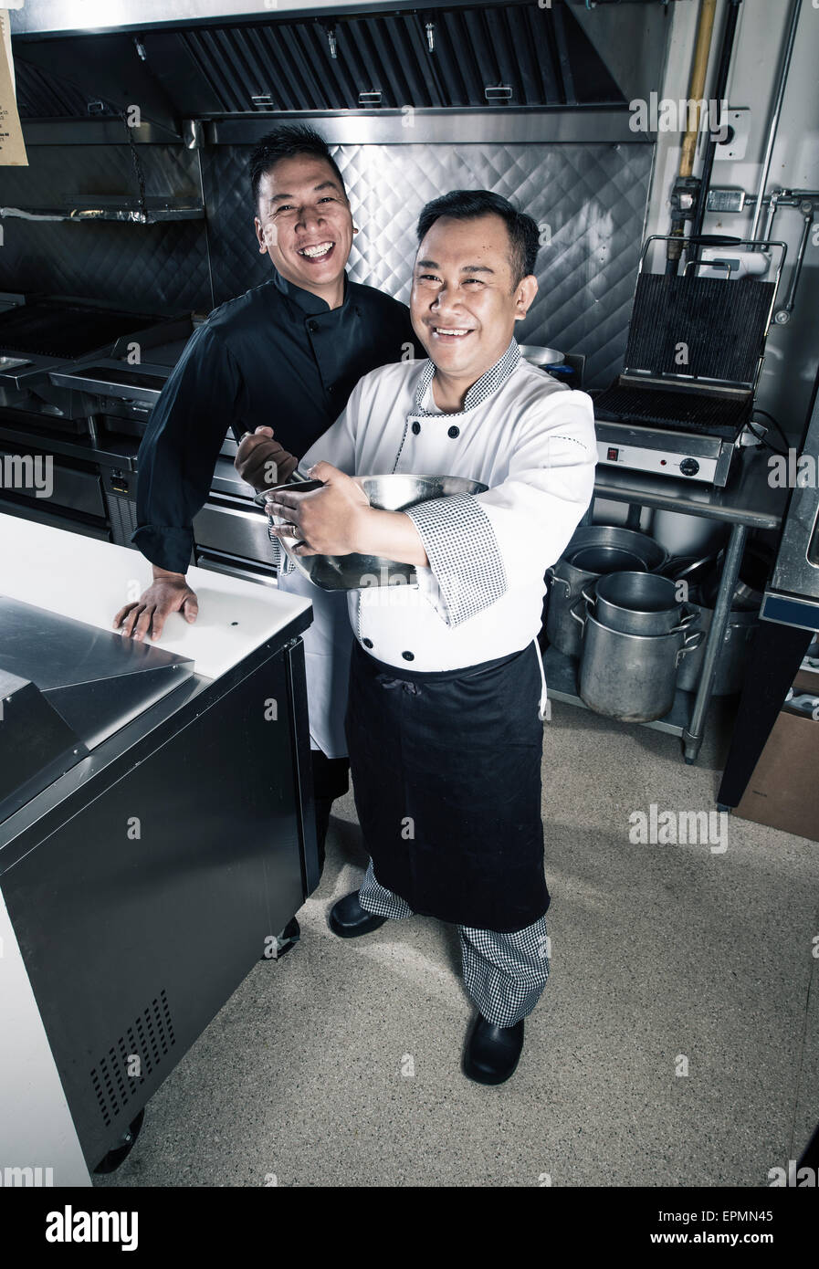 Two cooks in a commercial restaurant kitchen Stock Photo - Alamy