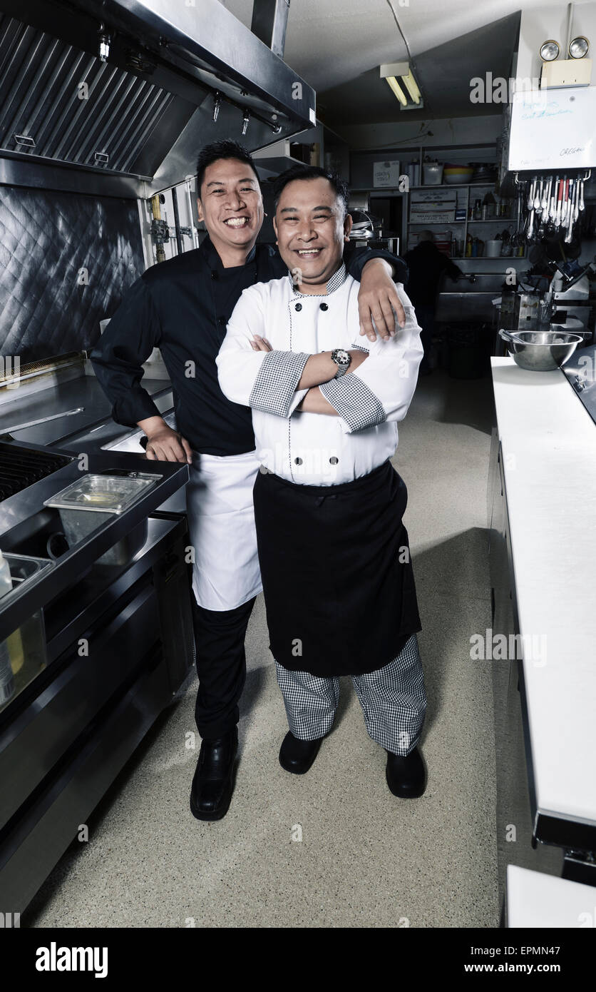 Two cooks in a commercial restaurant kitchen Stock Photo - Alamy