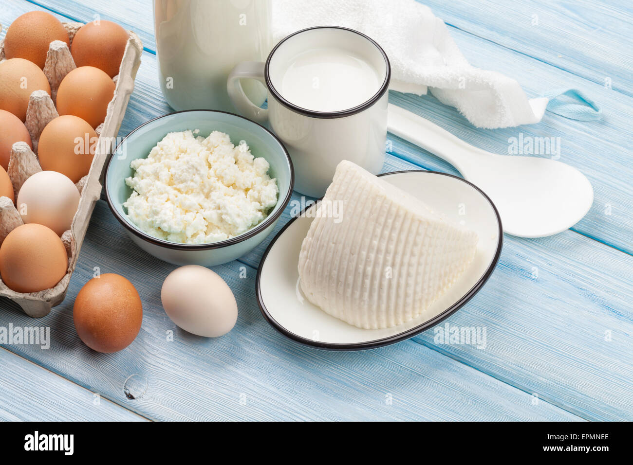 Dairy products on wooden table. Sour cream, milk, cheese, eggs and ...
