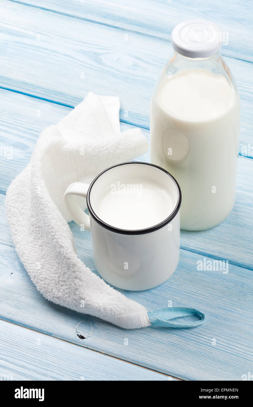 Milk cup and bottle on wooden table Stock Photo - Alamy