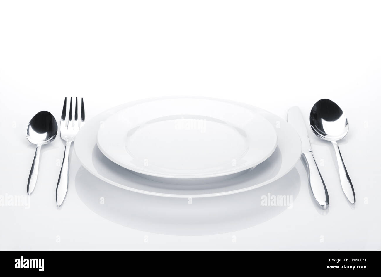 Silverware or flatware set and plates. Isolated on white background ...
