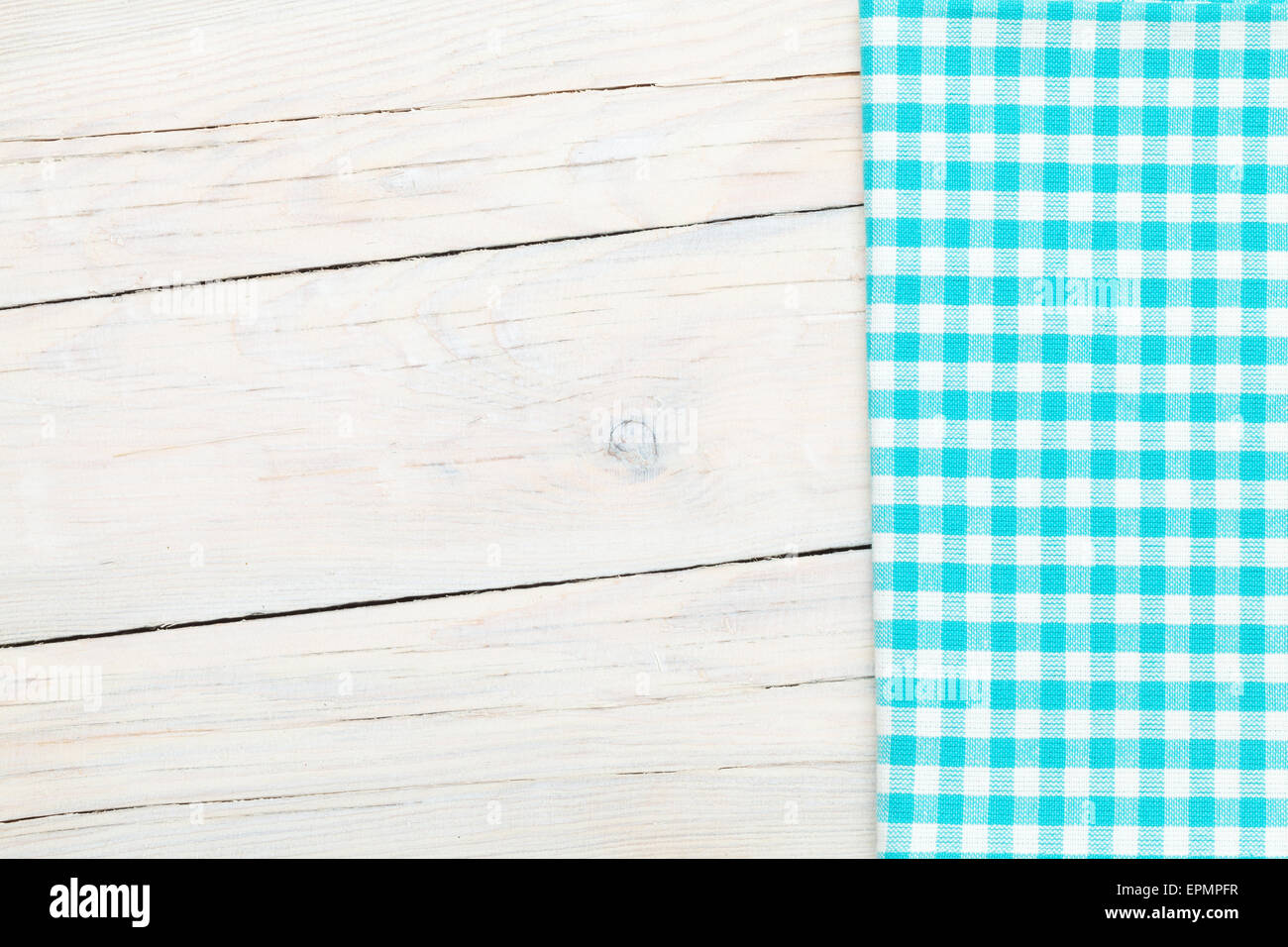 Blue towel over wooden kitchen table. View from above with copy space ...