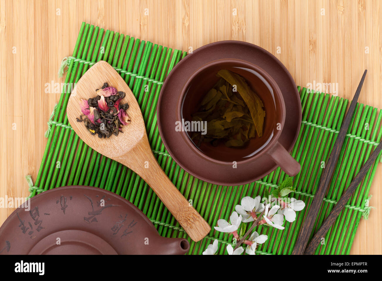 Japanese green tea and sakura branch over mat and bamboo table Stock ...