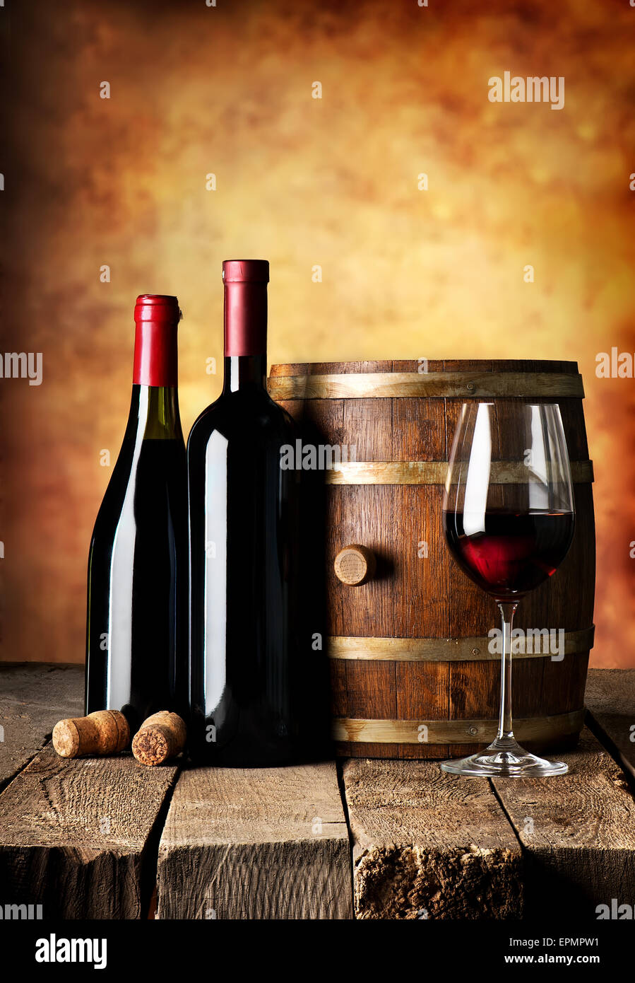 Bottles and cask of wine on a wooden table Stock Photo - Alamy