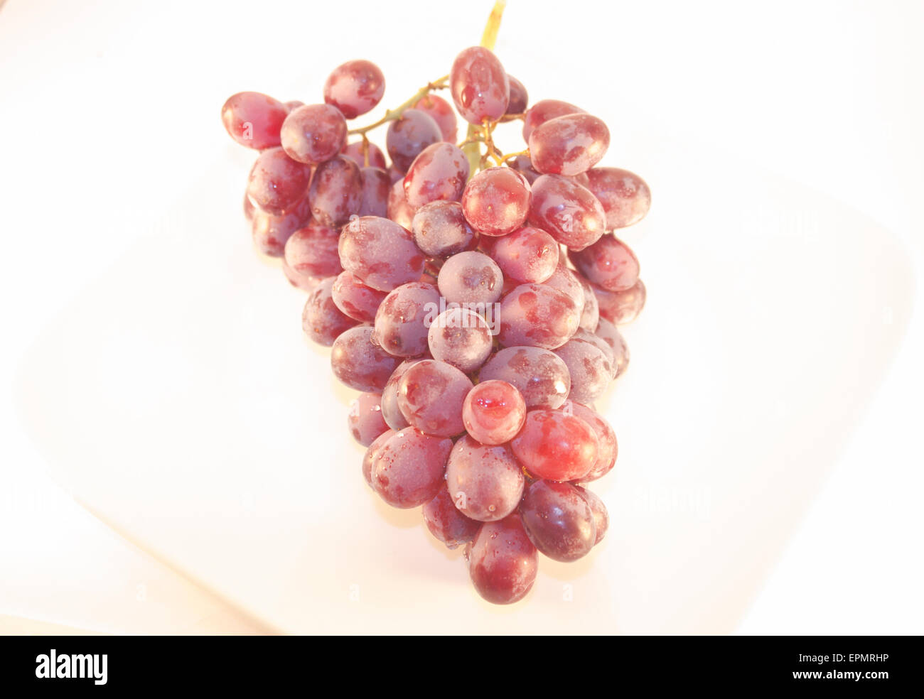 A cluster of purple grapes, isolated on white background Stock Photo ...