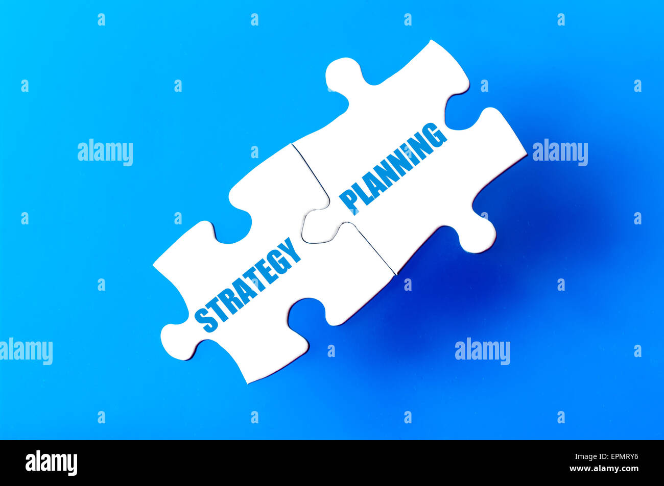 Connected puzzle pieces with words STRATEGY and PLANNING isolated over ...