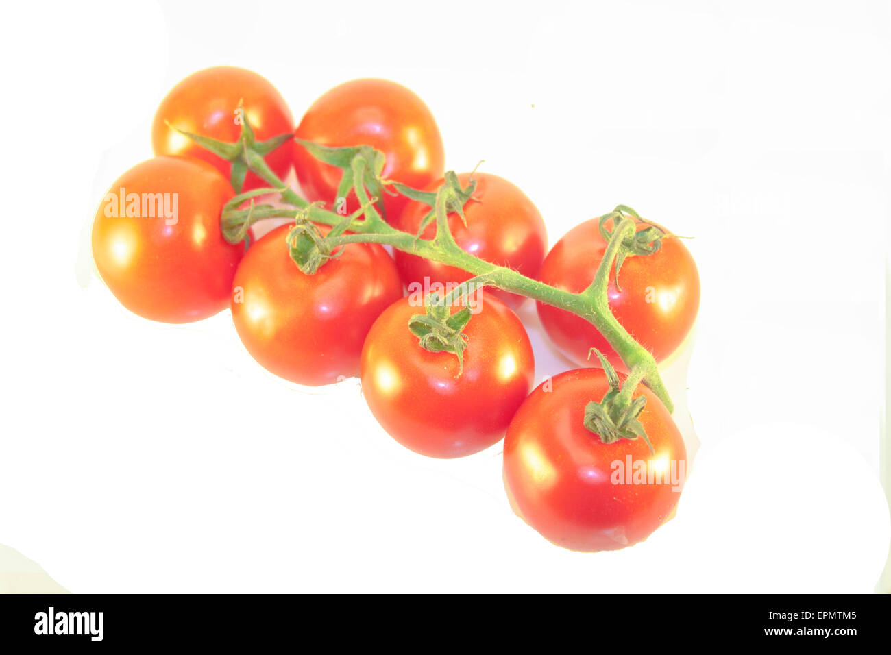 Eight small red tomatoes, in a cluster. Isolated on white background ...