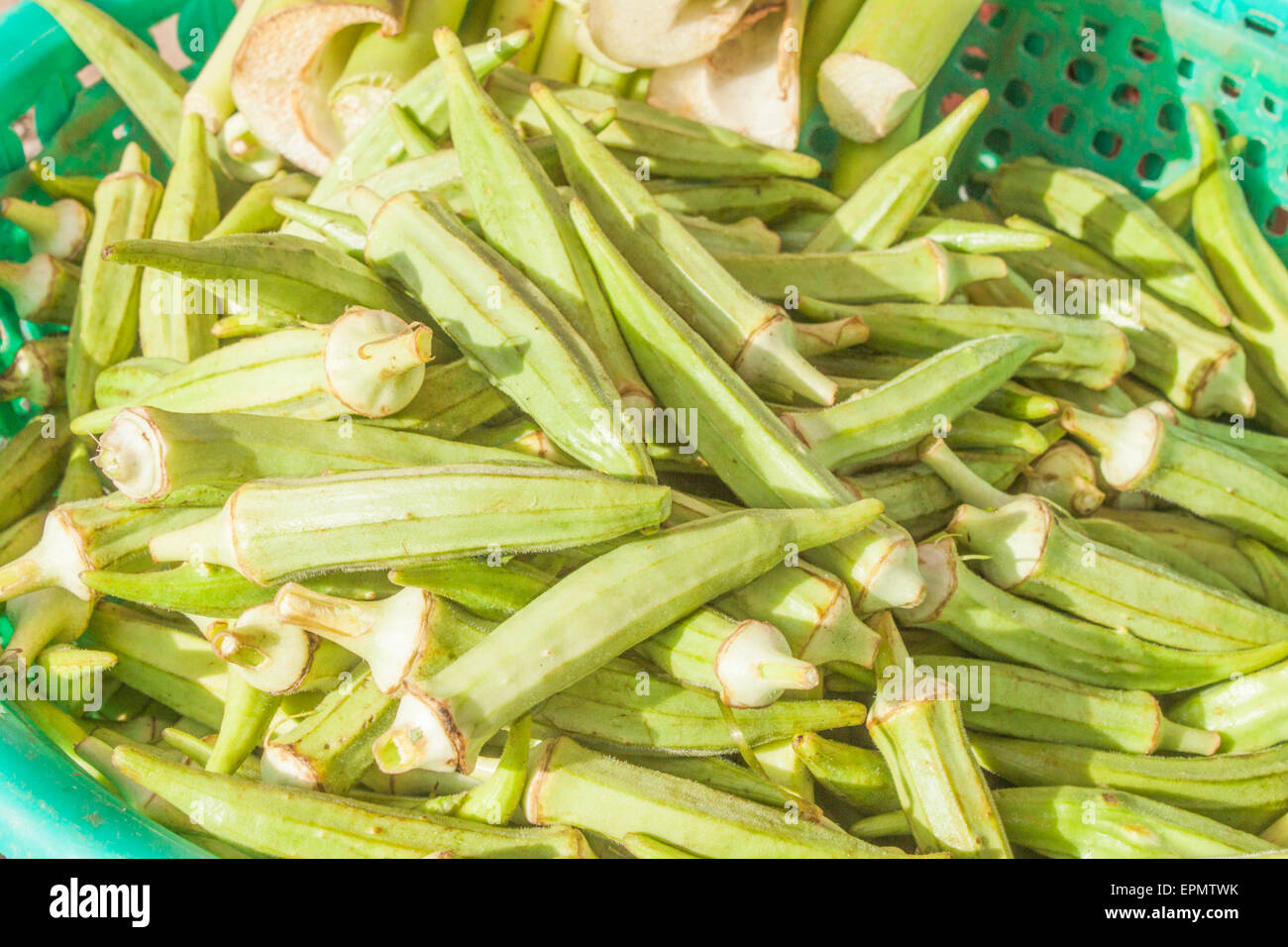 A pile of green okra in a basket, at a market Stock Photo - Alamy