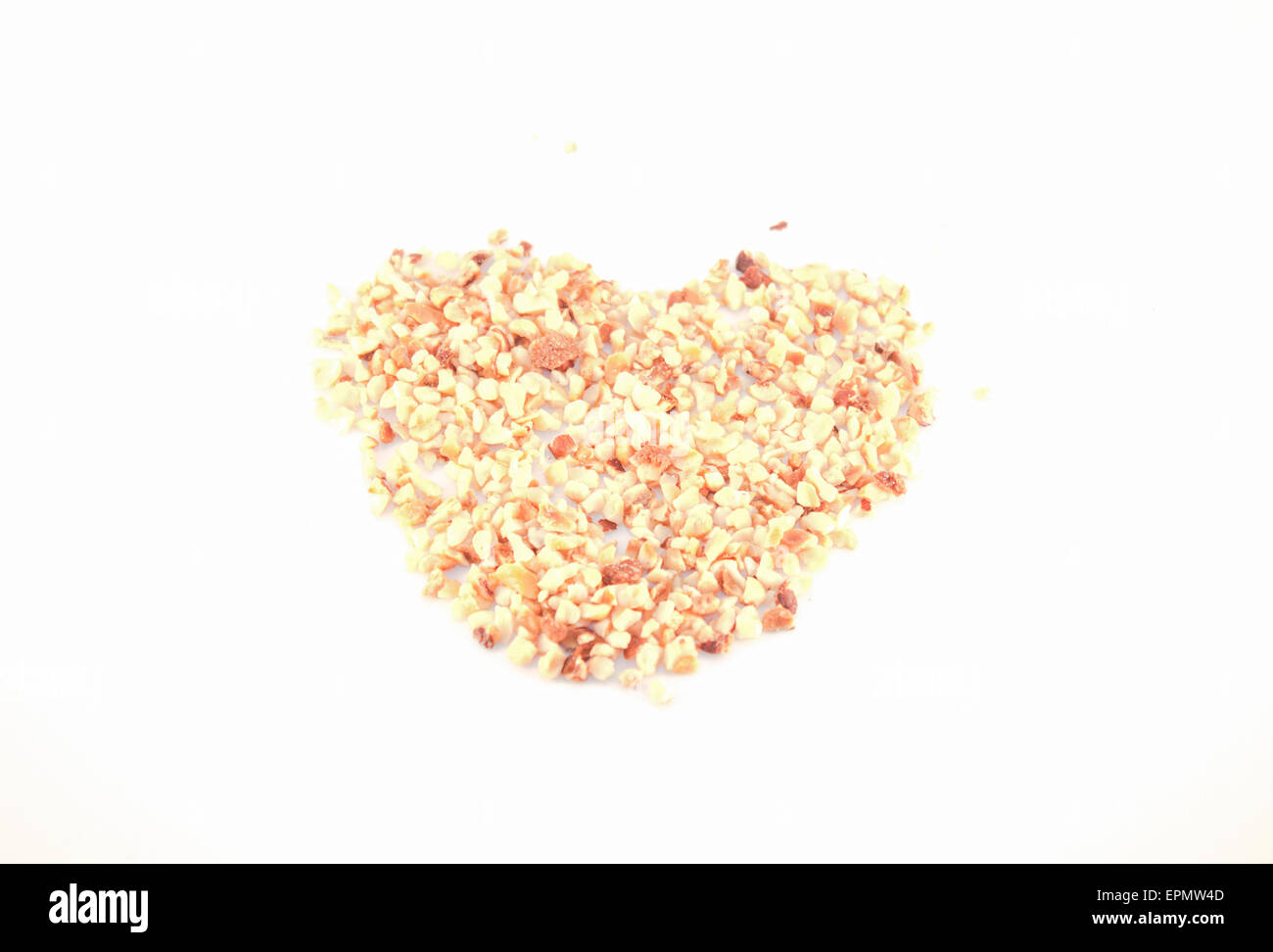 A heart of crushed hazelnuts, isolated on white background Stock Photo ...