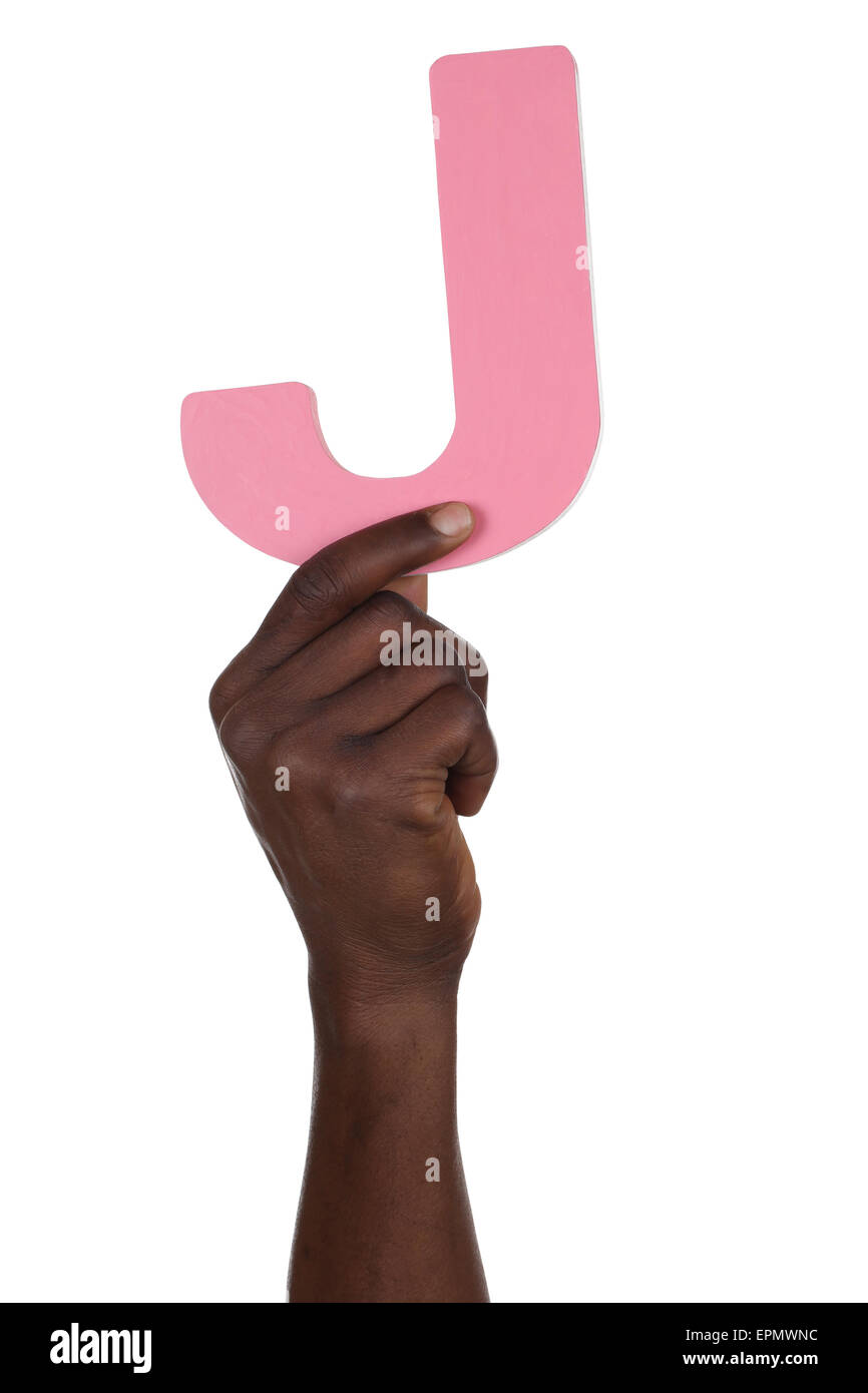 Hand holding letter J from alphabet isolated on a white background ...