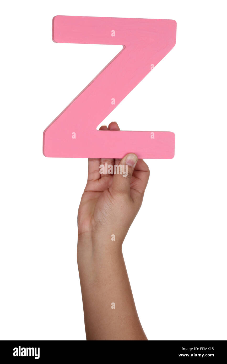 Hand holding letter Z from alphabet isolated on a white background ...