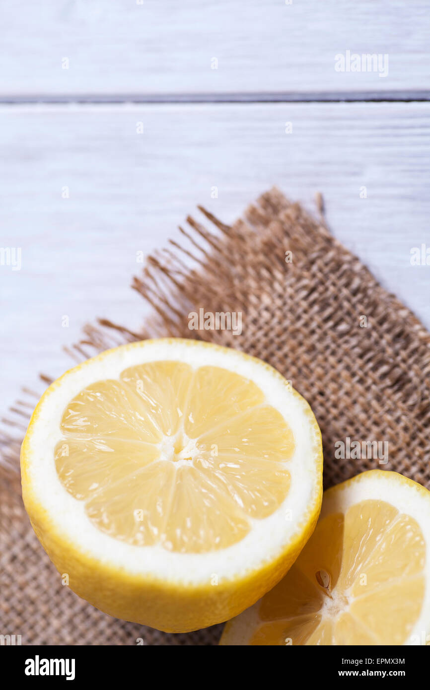 Lemon cut in half and sat on hessian material Stock Photo - Alamy