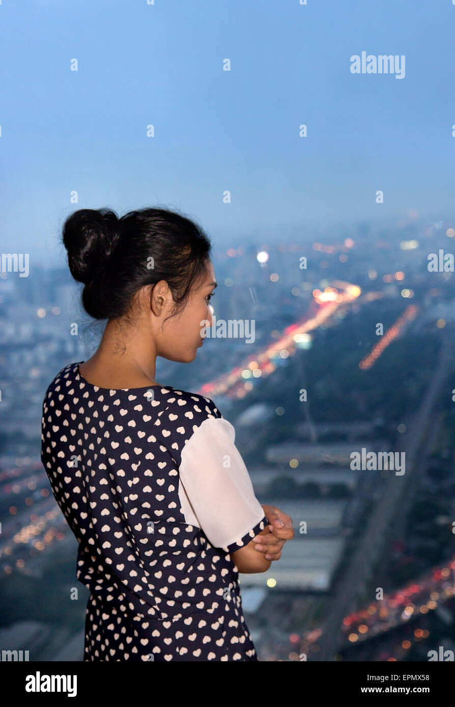 Young woman watching the view from skyscraper Stock Photo - Alamy
