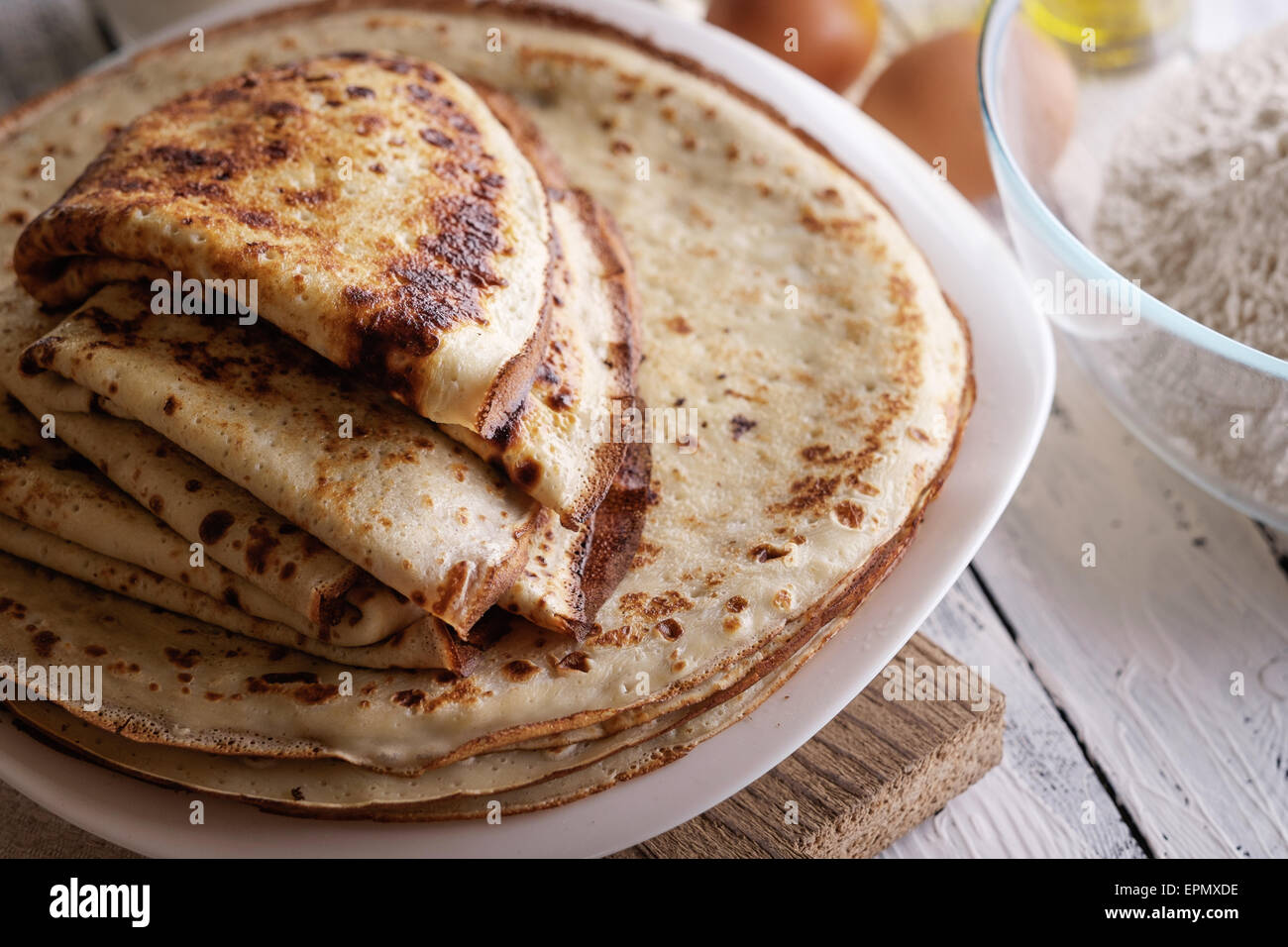 Close-up of Stack crepes and ingredients for cooking on a wooden table ...