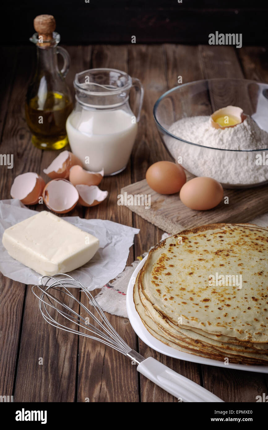 Stack of crepes and ingredients for cooking on a wooden table Stock ...