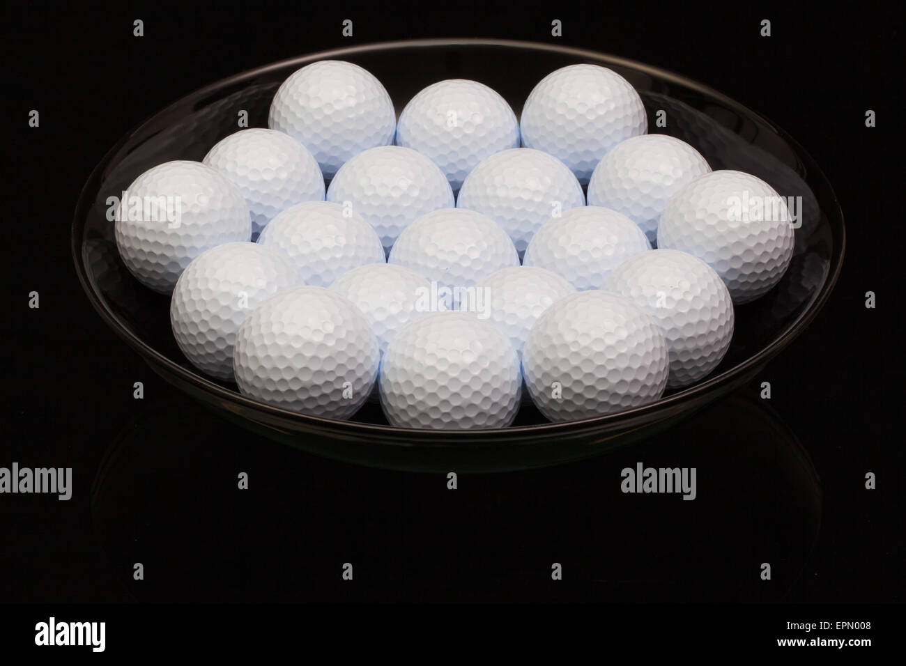 Black ceramic bowl full of white golf balls Stock Photo - Alamy