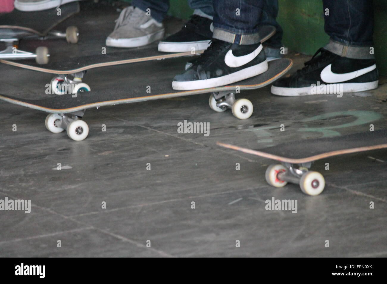 Young friends holding skateboards in hands outdoor on city skate park ...