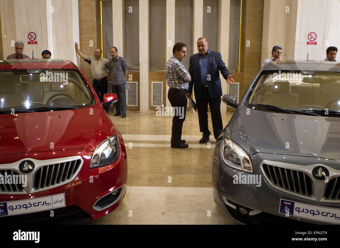 Tehran, Iran. 19th May, 2015. Iranian customers watch model cars of the ...