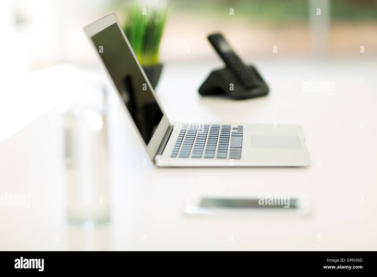 office desk with laptop, cell phone, telephone Stock Photo - Alamy
