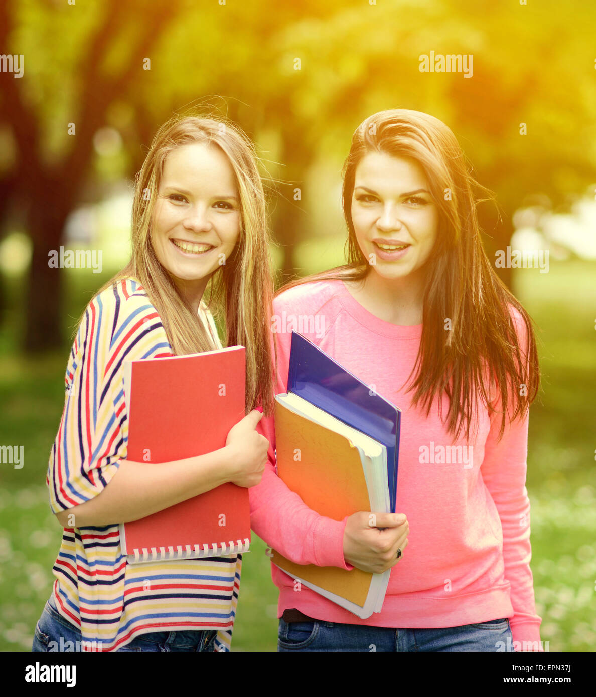 Happy students in summer park Stock Photo - Alamy