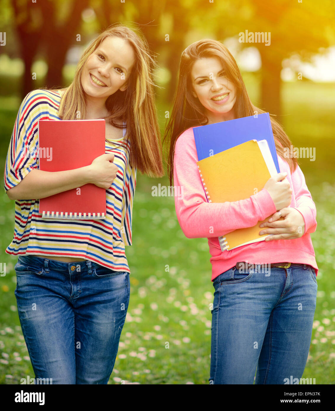 Happy students in summer park Stock Photo - Alamy