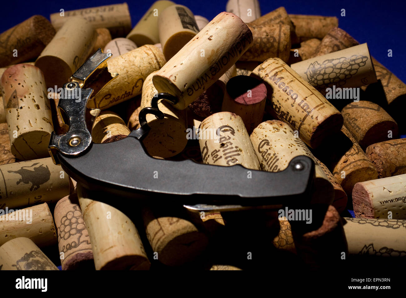 A bunch of Wine corks with a waiters cork screw Stock Photo - Alamy