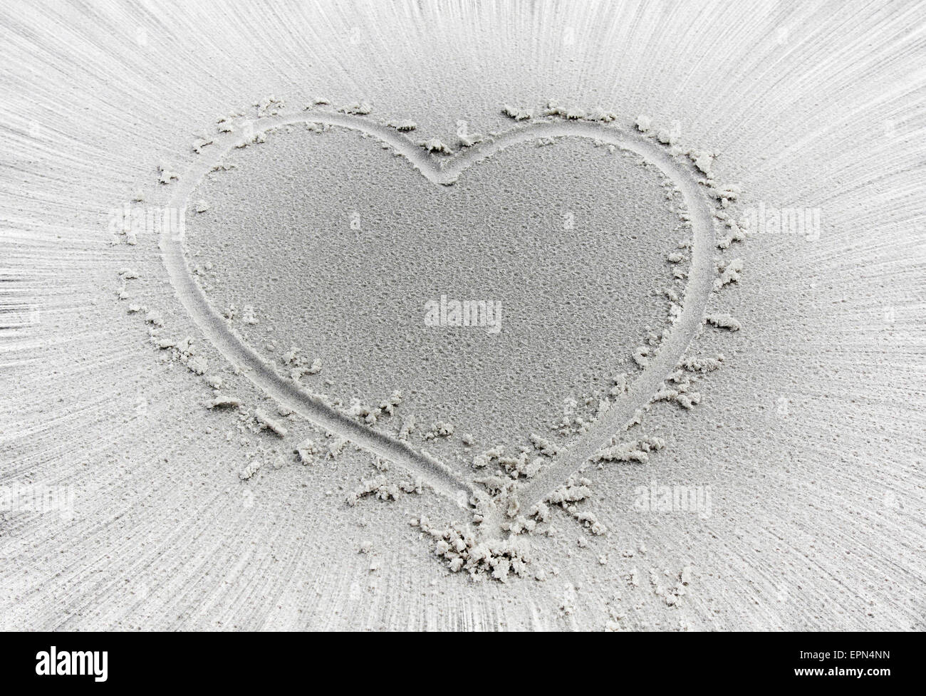 heart shape in the sand with rays around Stock Photo - Alamy