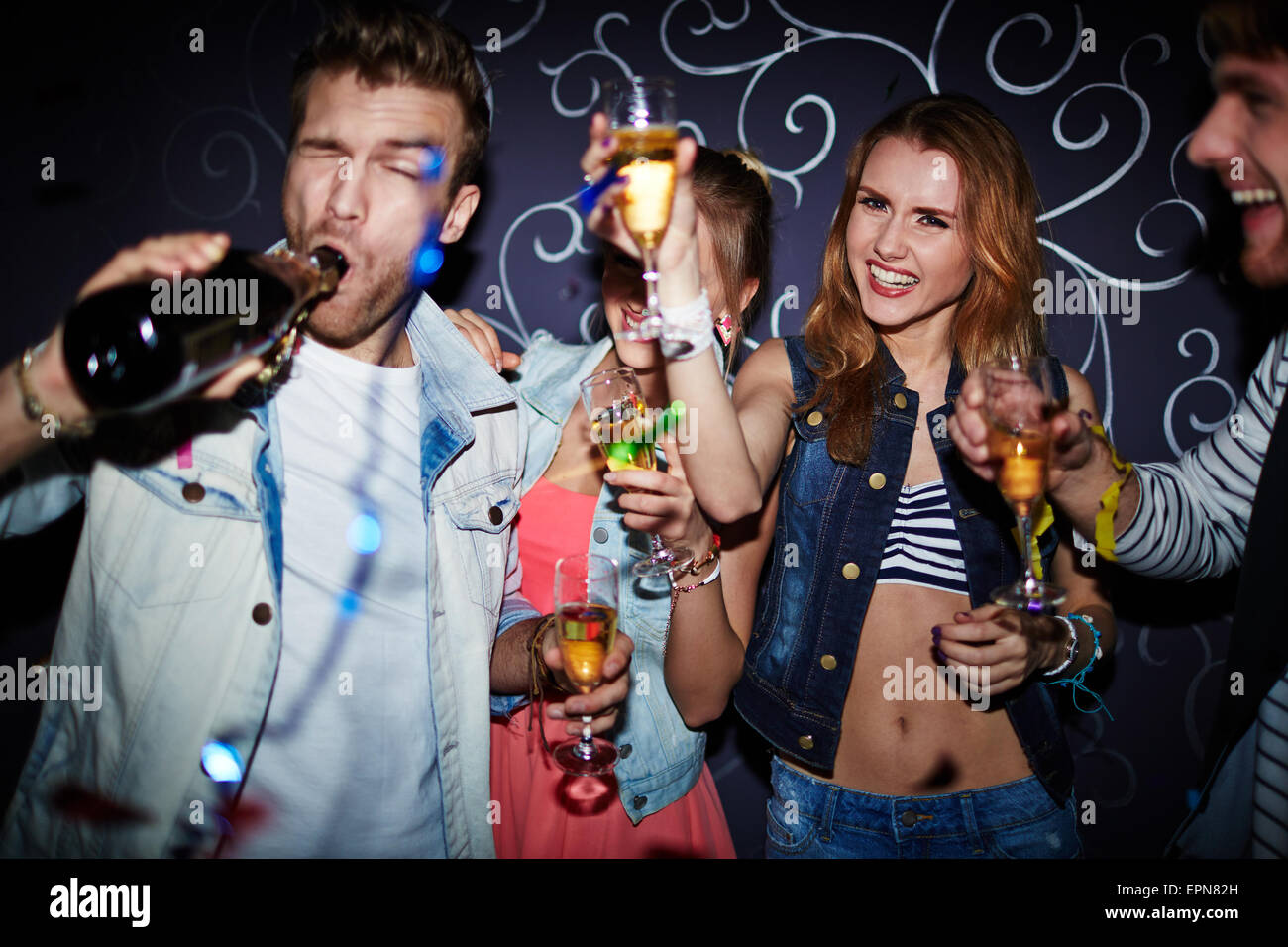 Group of clubbing friends with champagne having fun at party Stock ...