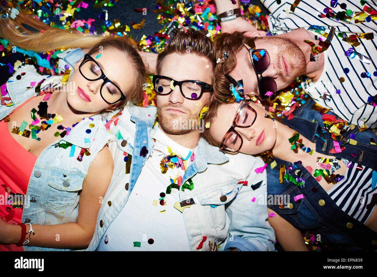 Sleeping friends lying on the floor in nightclub Stock Photo - Alamy