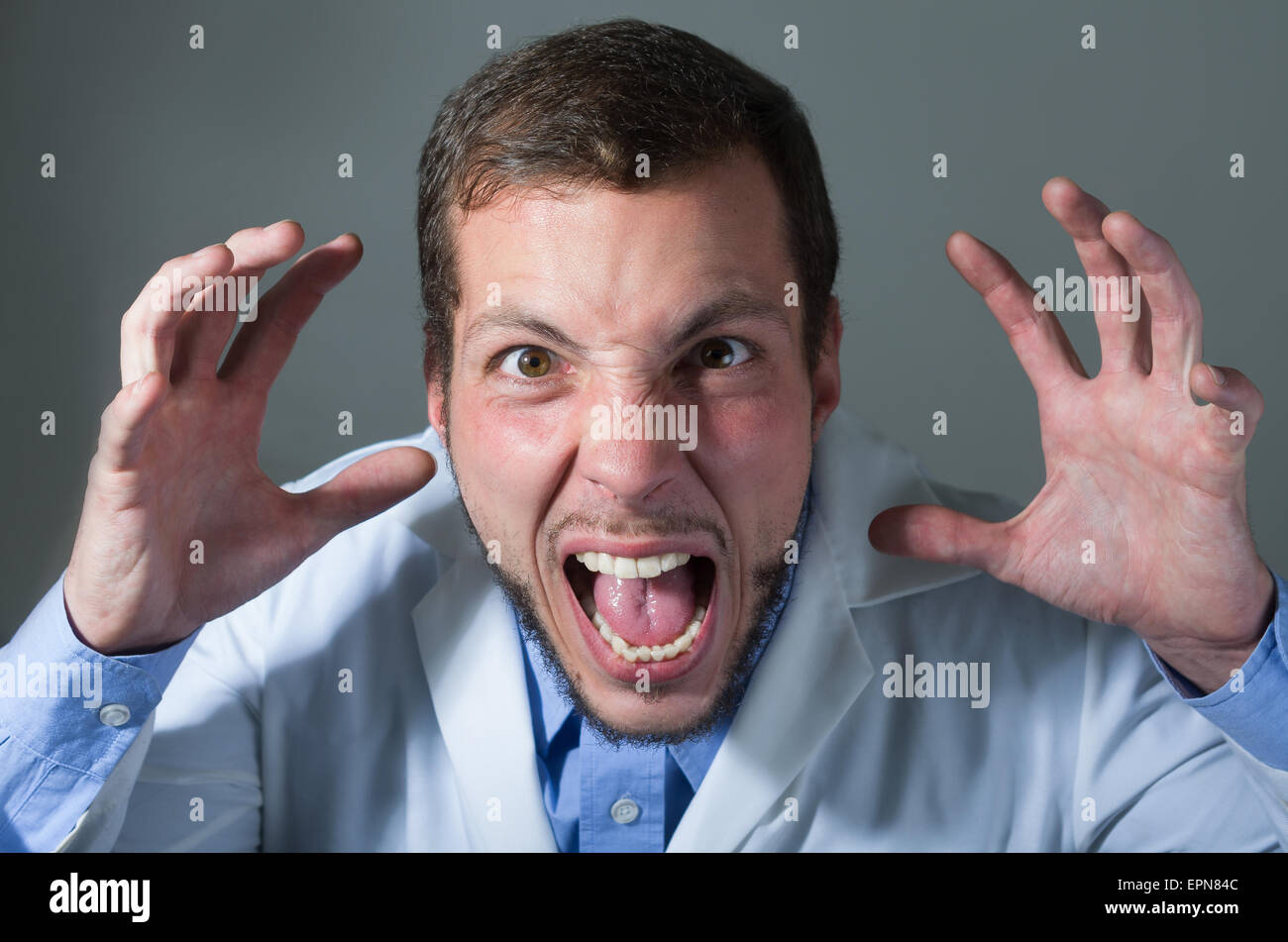 Closeup portrait of handsome young doctor screaming Stock Photo - Alamy
