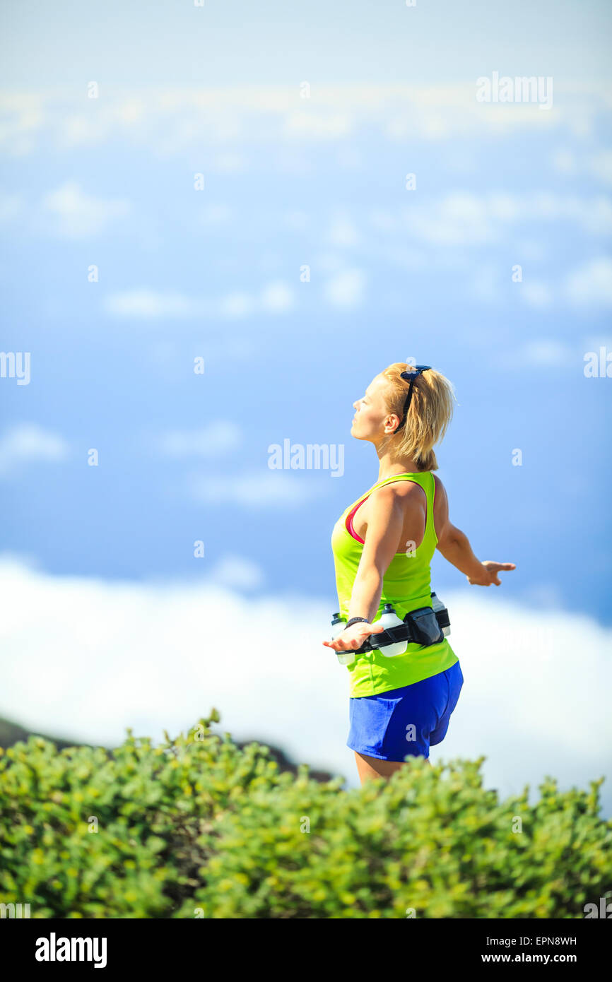 Happy woman runner joyful with arms raised outstretched smiling and ...