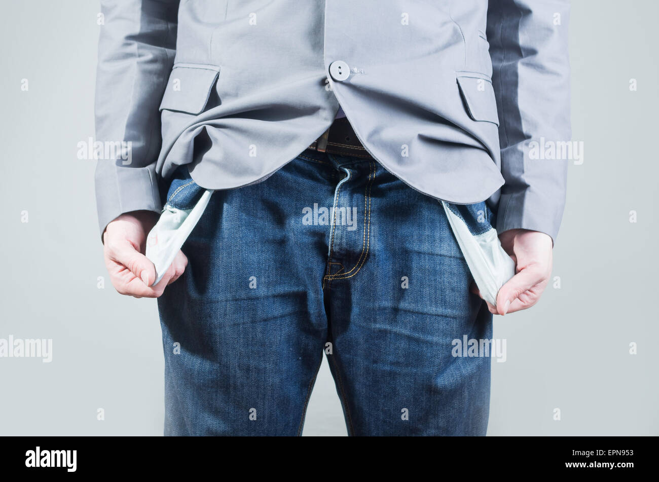Close up shot of man holding out his empty pockets Stock Photo - Alamy