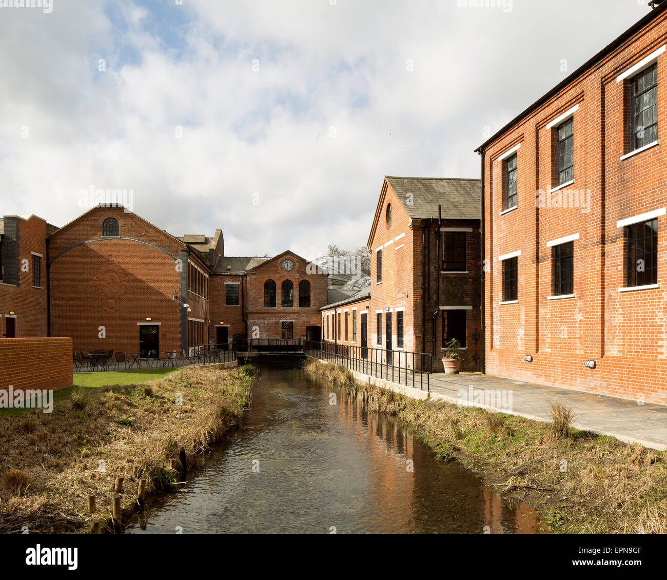 Exterior view of distillery building looking along River Test. Bombay ...